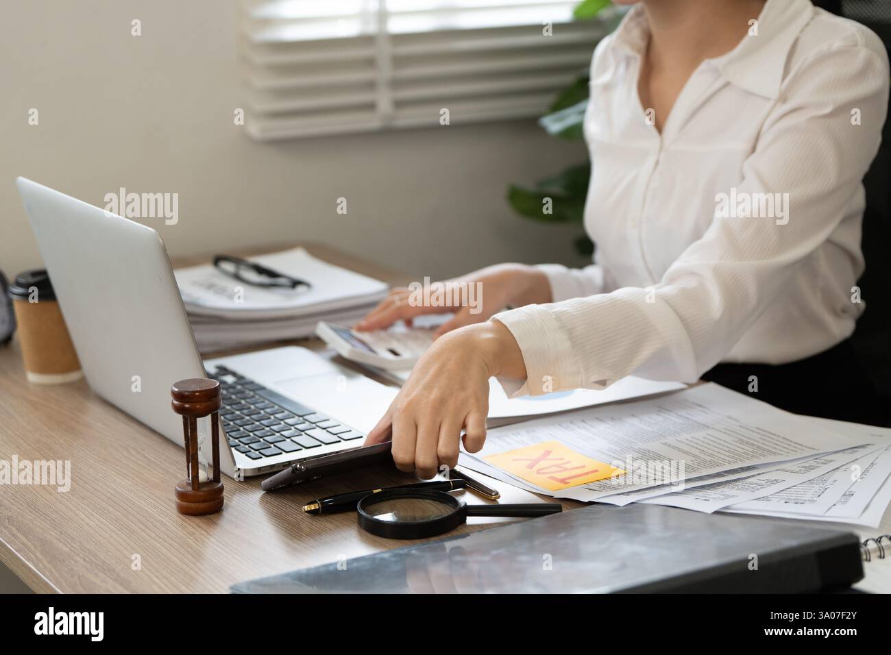 Professional preparing tax documents and managing financial tasks at ...