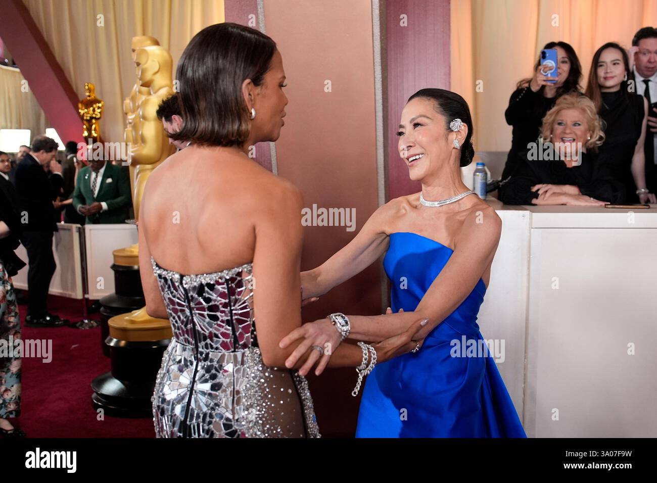 Halle Berry, left, and Michelle Yeoh arrive at the Oscars on Sunday ...