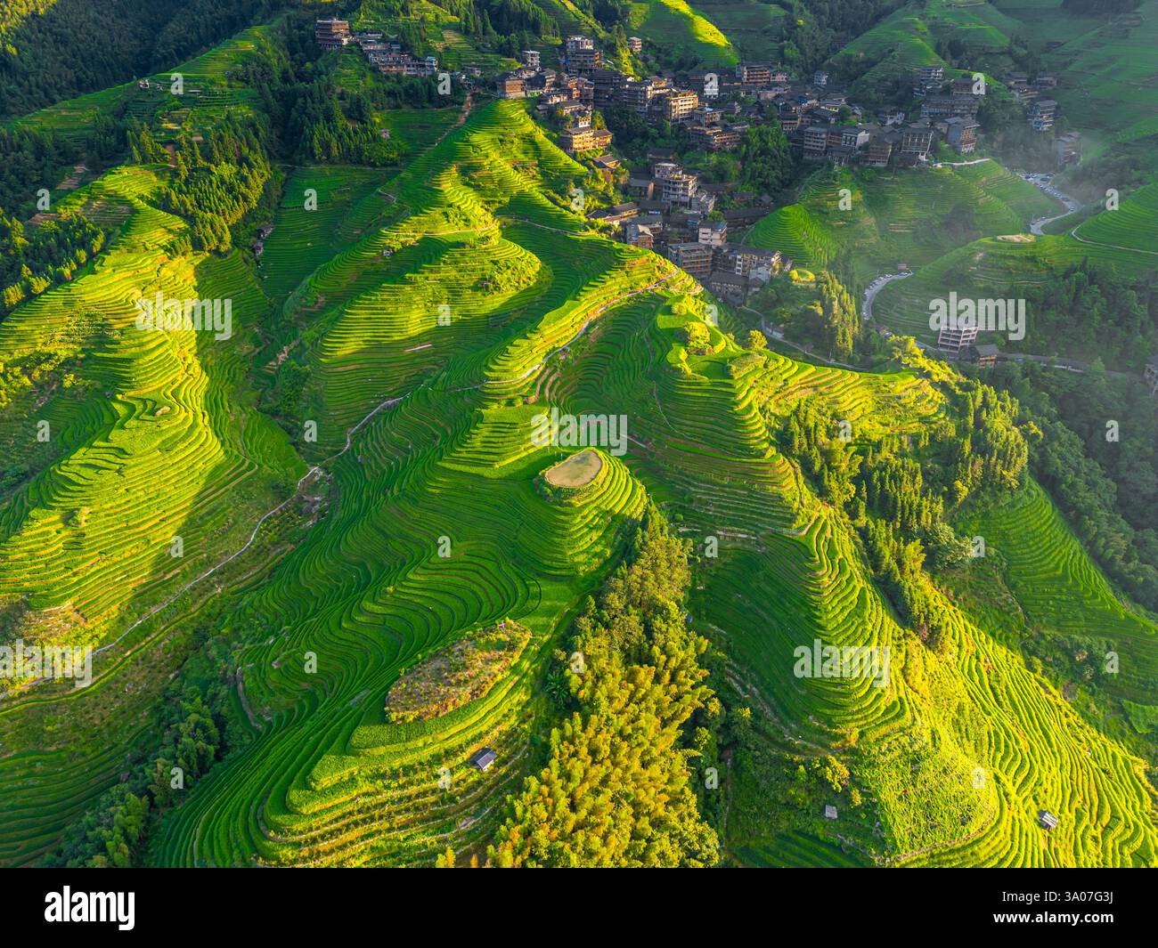 Mountain, village and rice terraces at Longji Rice Terraces in China ...