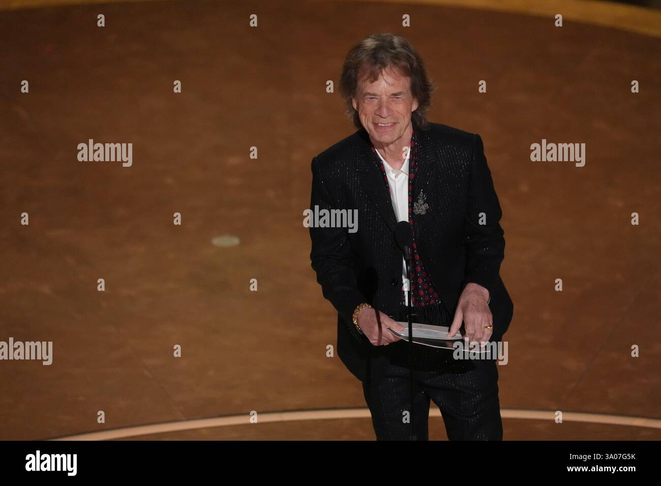 Mick Jagger presents the award for best original song during the Oscars ...