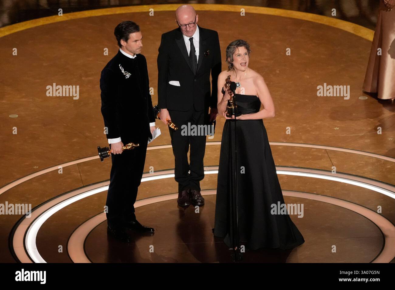 Clement Ducol, from left, Jacques Audiard, and Camille accept the award ...