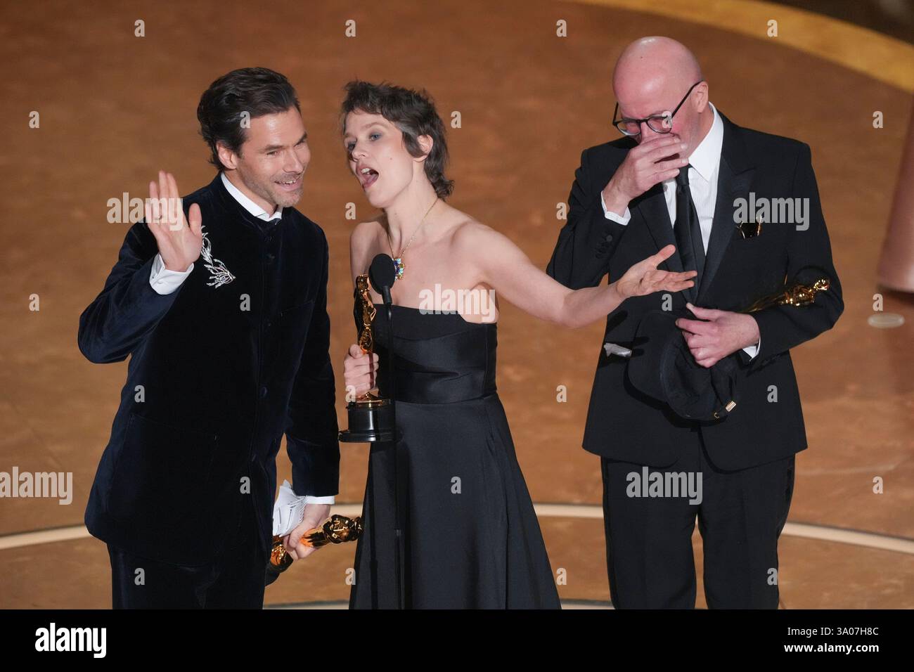 Clement Ducol, from left, Camille, and Jacques Audiard accept the award ...