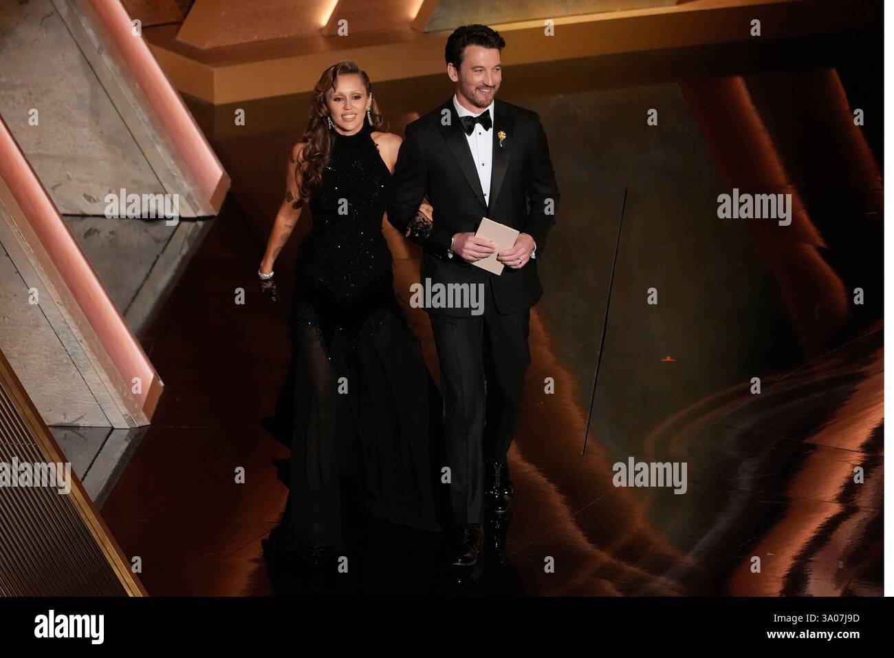 Miley Cyrus, left, and Miles Teller present the award for best sound ...