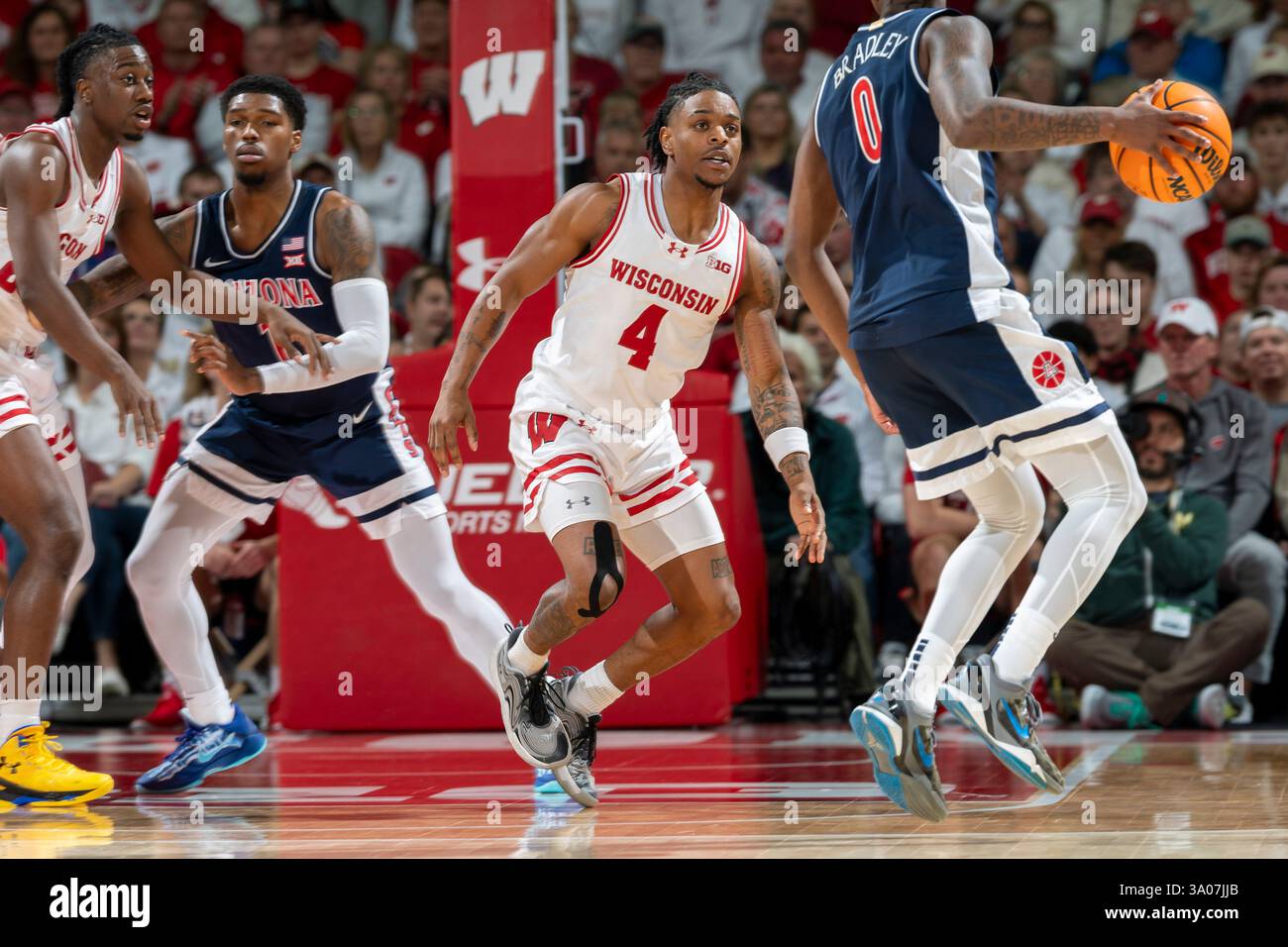 Wisconsin Badgers guard Kamari McGee (4) defends during an NCAA college ...