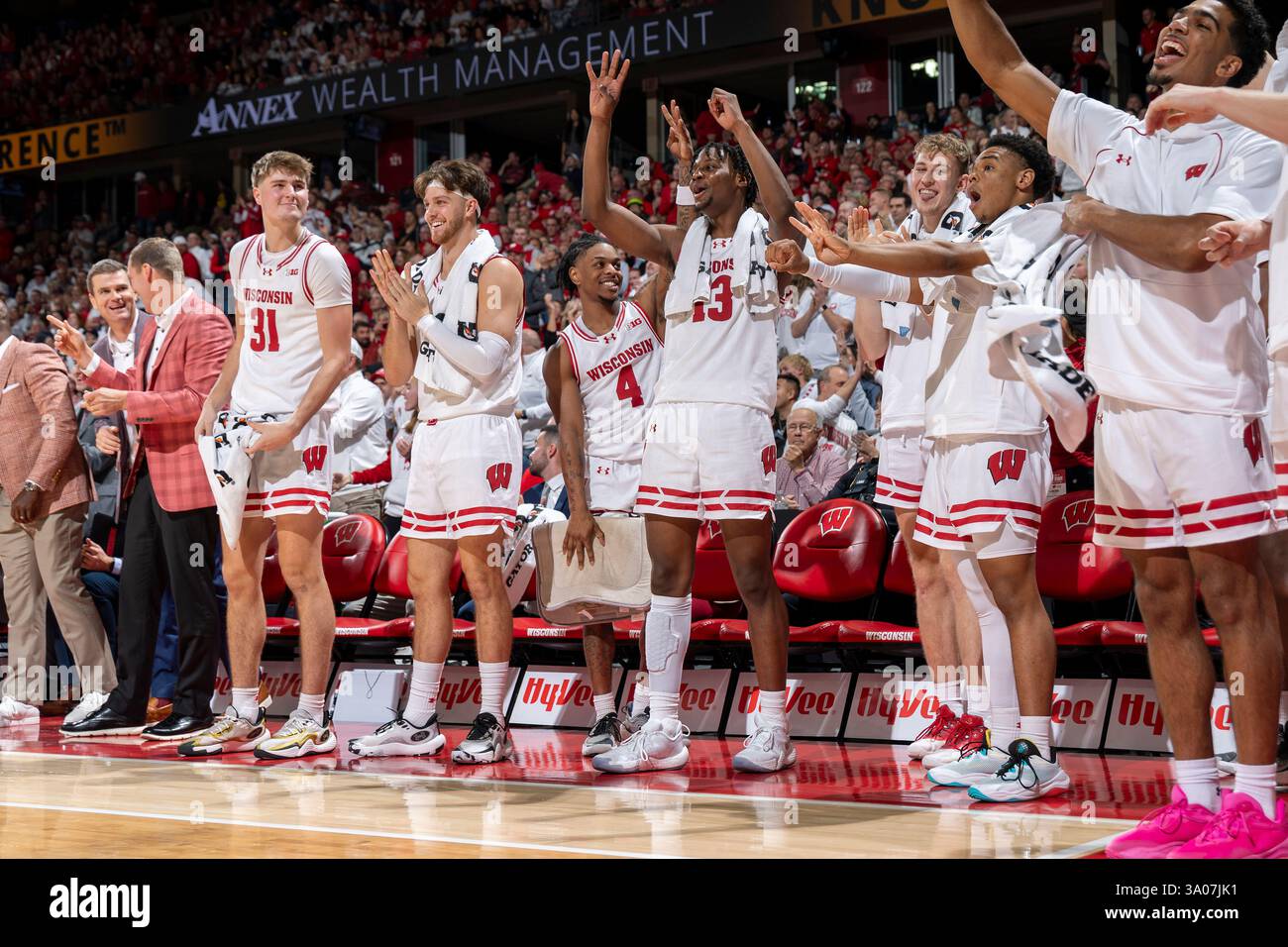 Wisconsin Badgers teammates cheer during an NCAA college men's ...