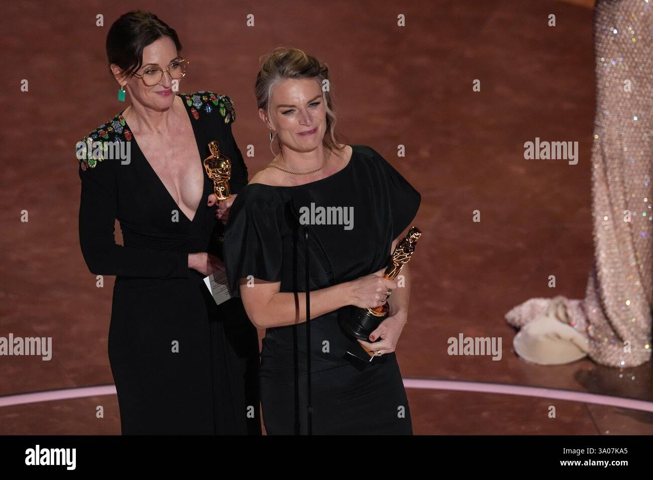 Molly O'Brien, left, and Lisa Remington accept the award for best documentary short film for ...