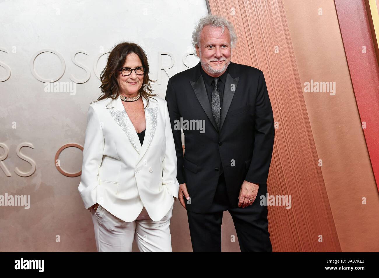 Emily Karaszewski, left, and Larry Karaszewski arrive at the Oscars on ...