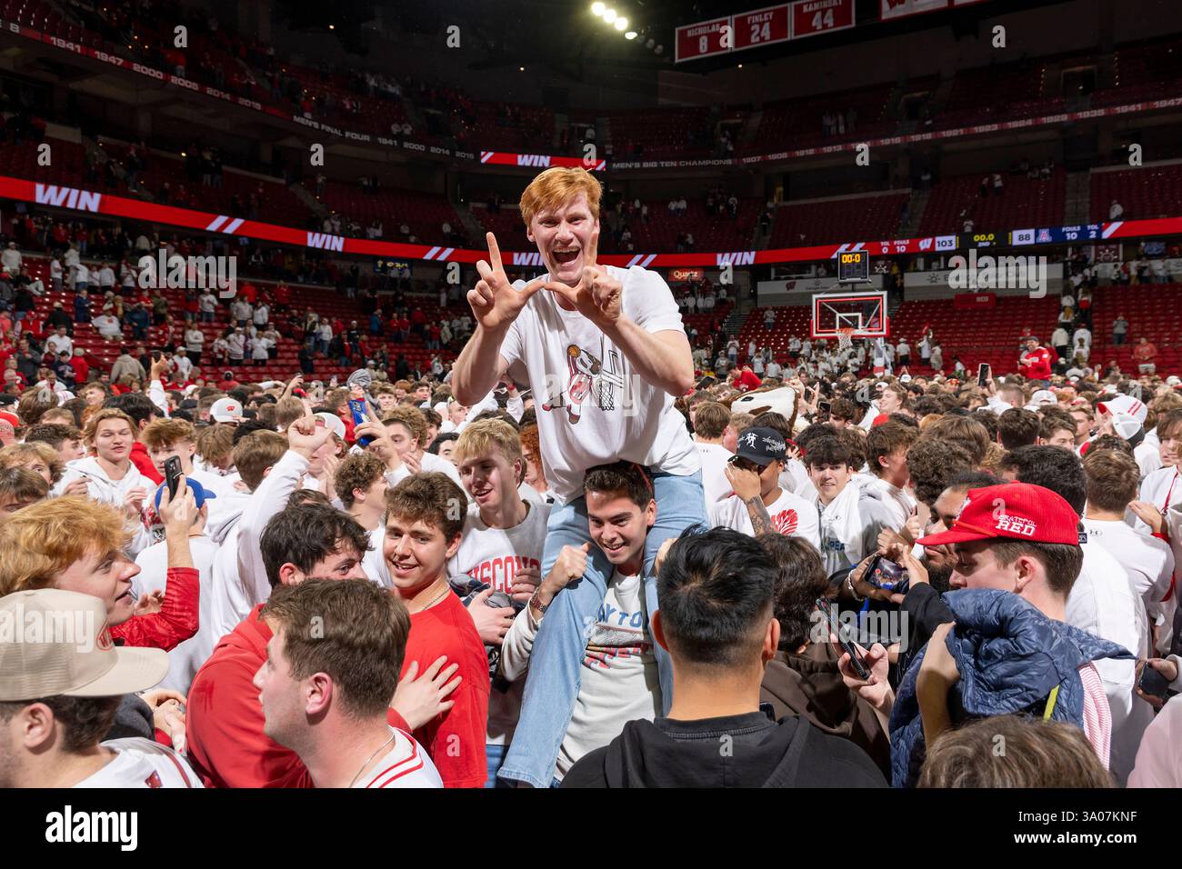 Wisconsin Badger fans rush the court after an NCAA college men's ...