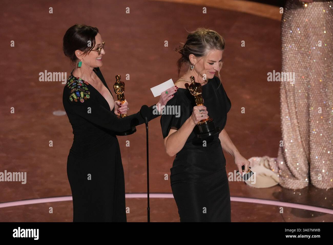 Molly O'Brien, left, and Lisa Remington accept the award for best documentary short film for ...