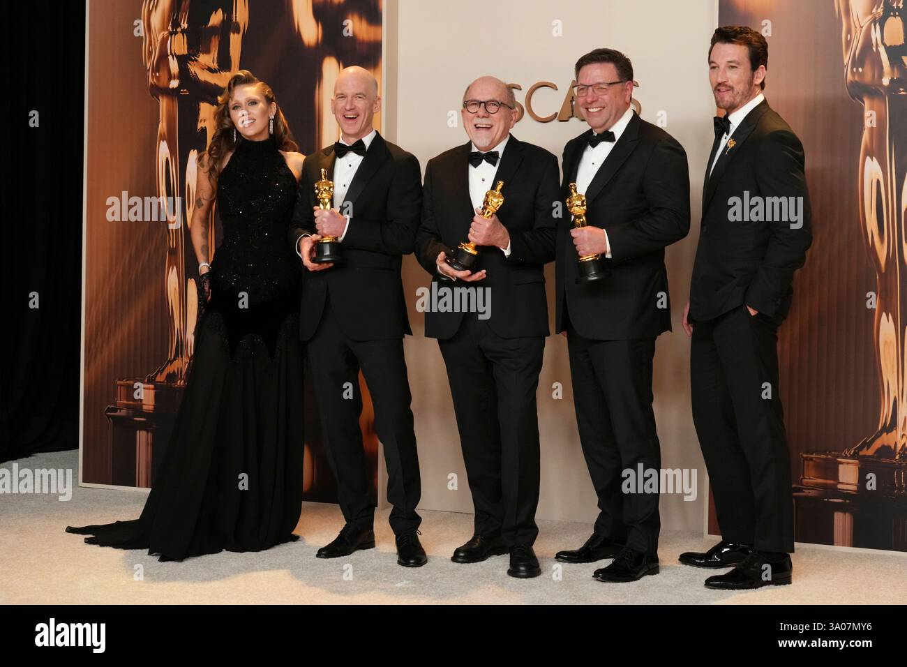Miley Cyrus, left, and Miles Teller, right, pose with Gareth John ...