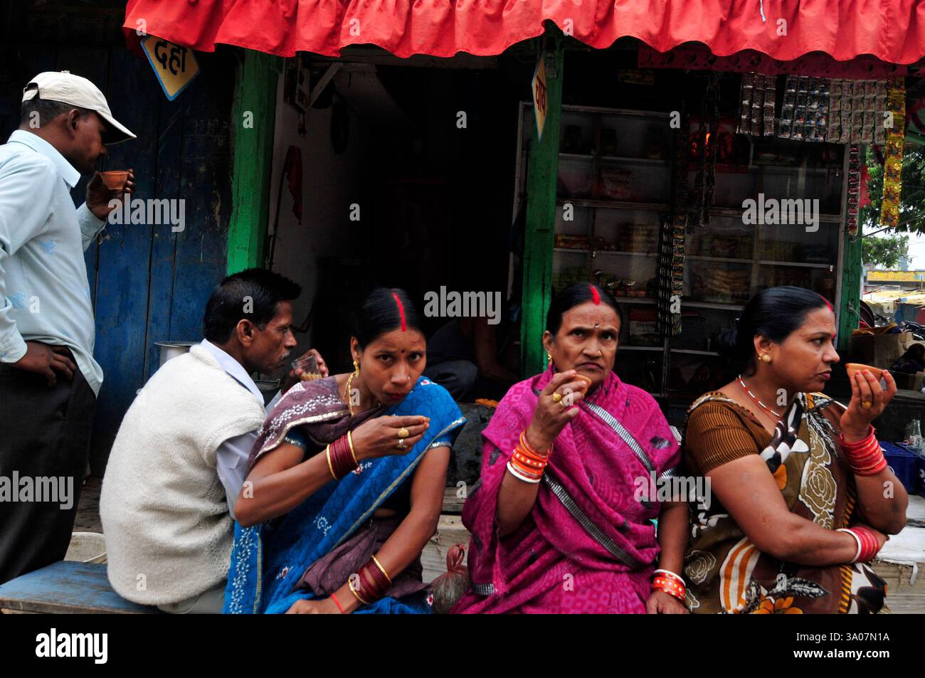 Women drinking Chai on the street by one of the many temples in Ayodhya ...