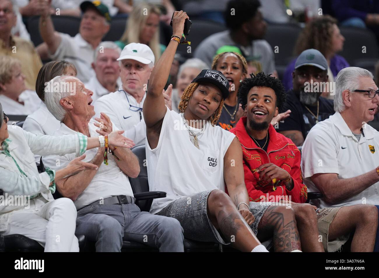 WNBA player and former Baylor player, NaLyssa Smith, center with arm ...