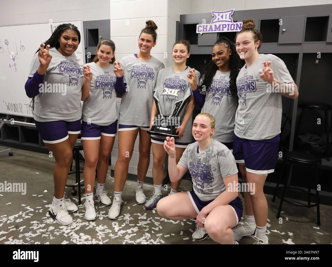 TCU players pose in the locker room with their trophy after defeating ...