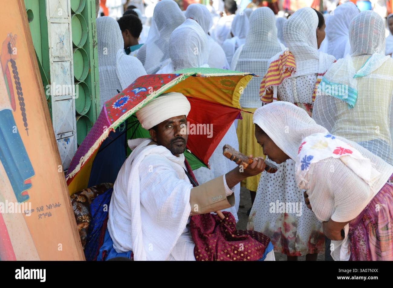 An Ethiopian Orthodox priest blessing worshippers at a local church ...