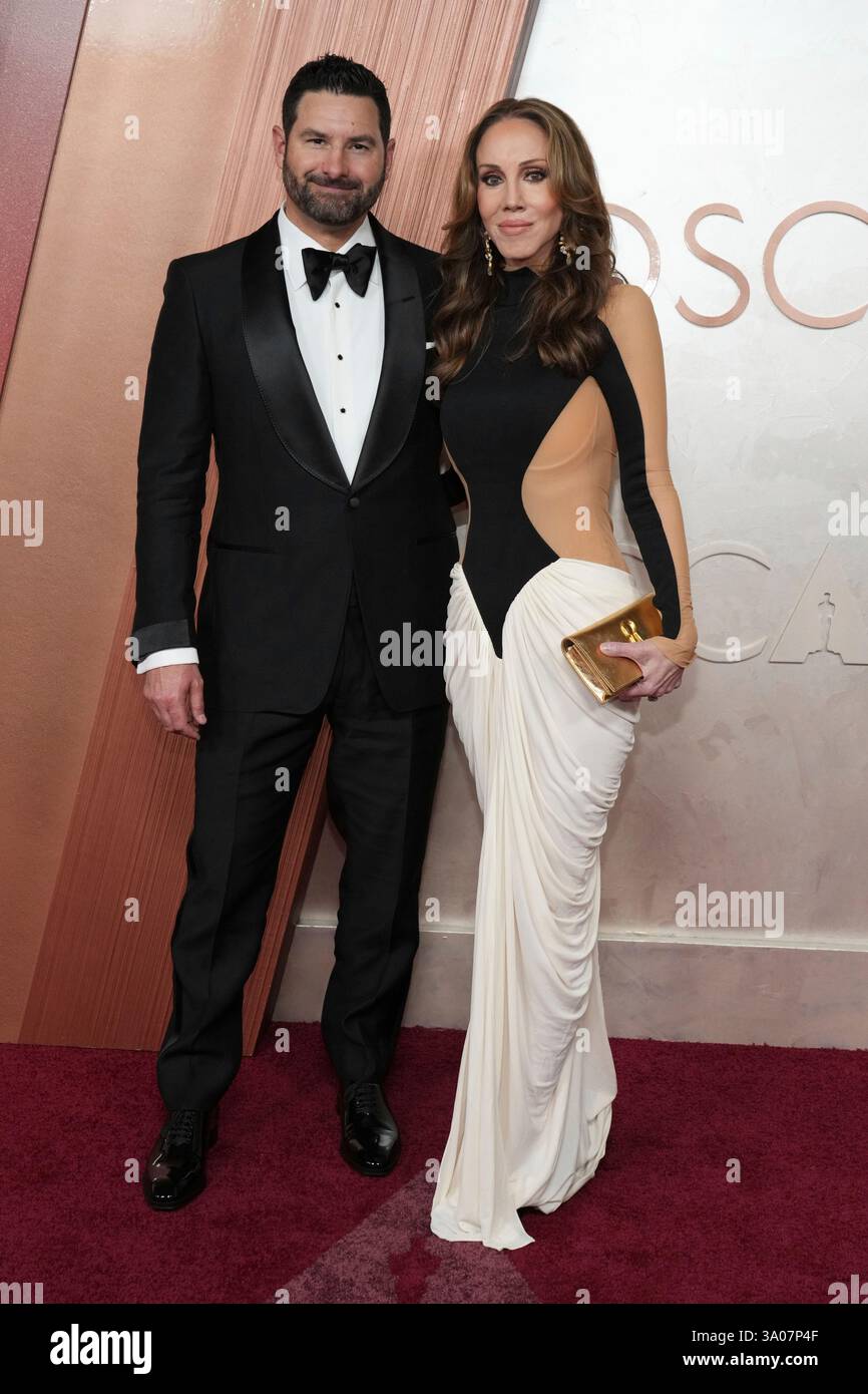 Javier Chapa, left and Mary Parent arrive at the Oscars on Sunday ...