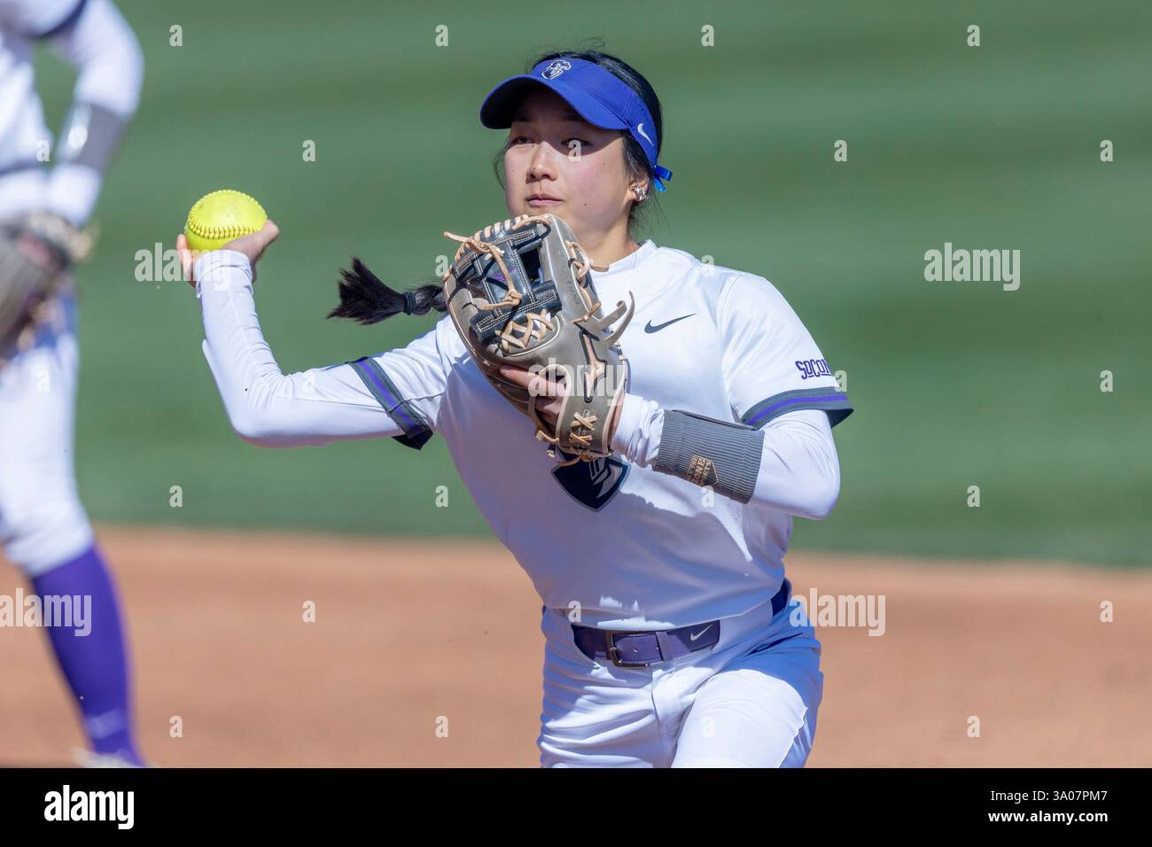 Furman infielder Ansley Chiang (8) throws to first base to get an out ...
