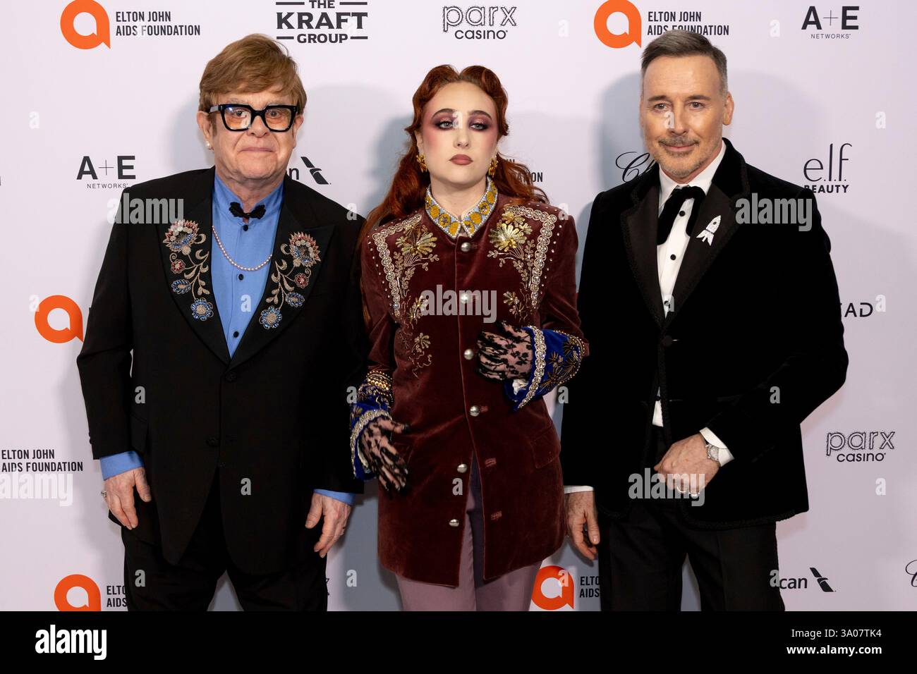 Elton John, from left, Chapell Roan and David Furnish arrive at the ...