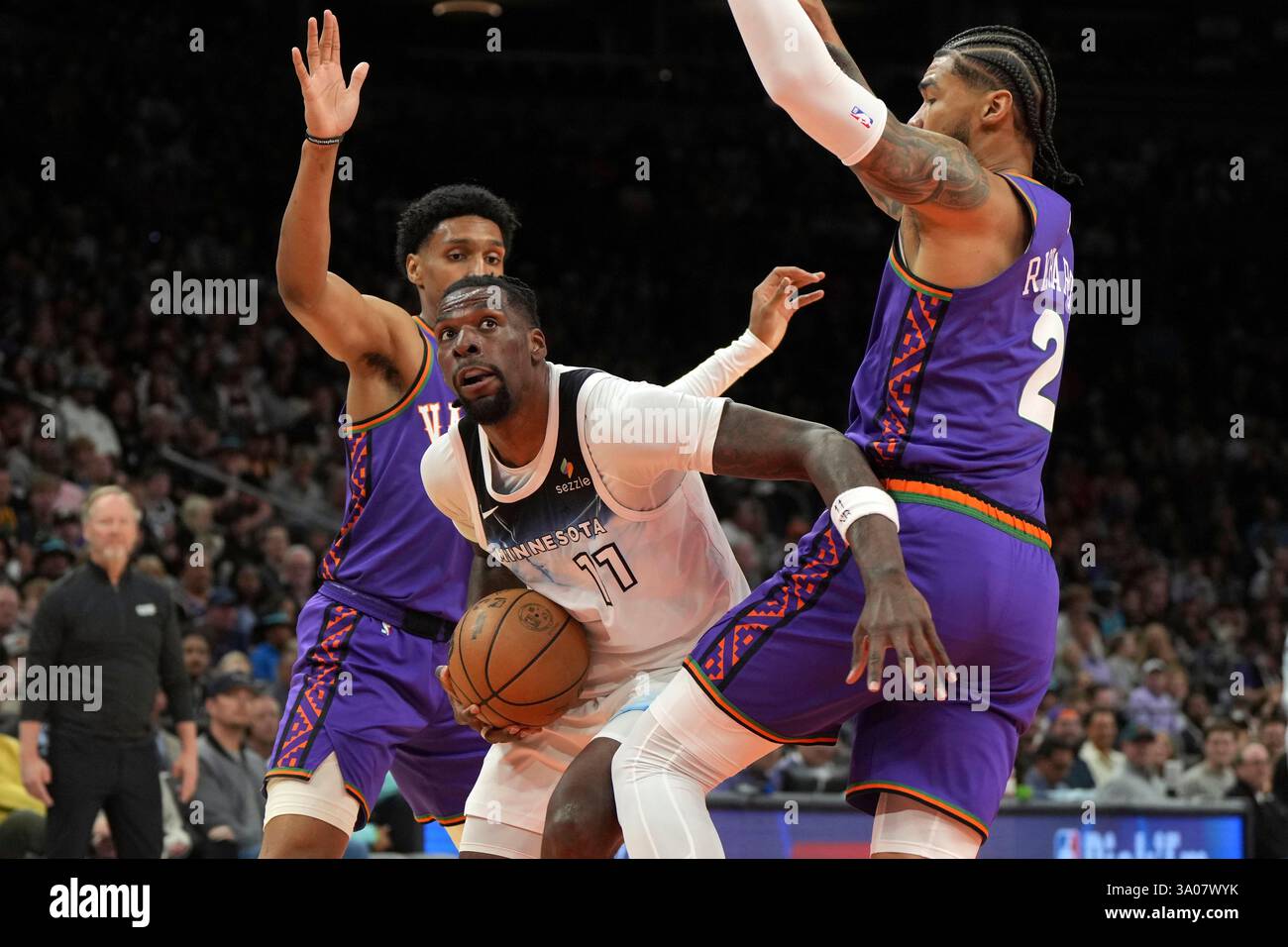 Minnesota Timberwolves center Naz Reid drives between Phoenix Suns ...