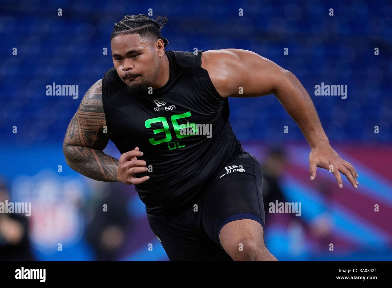 Arizona offensive lineman Jonah Savaiinaea runs a drill at the NFL ...