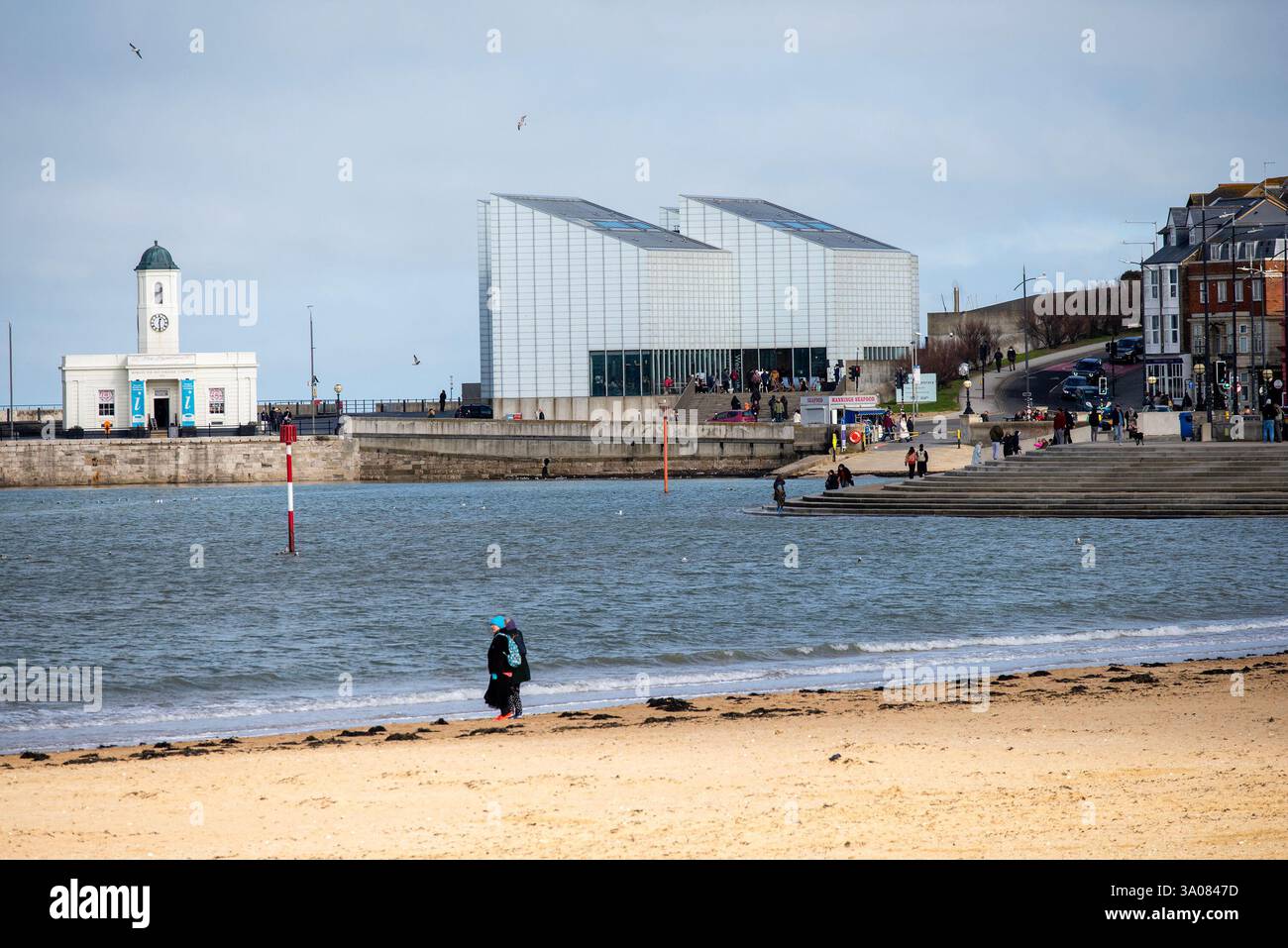 People walk on the seafront at the Margate Harbour. Margate is a ...