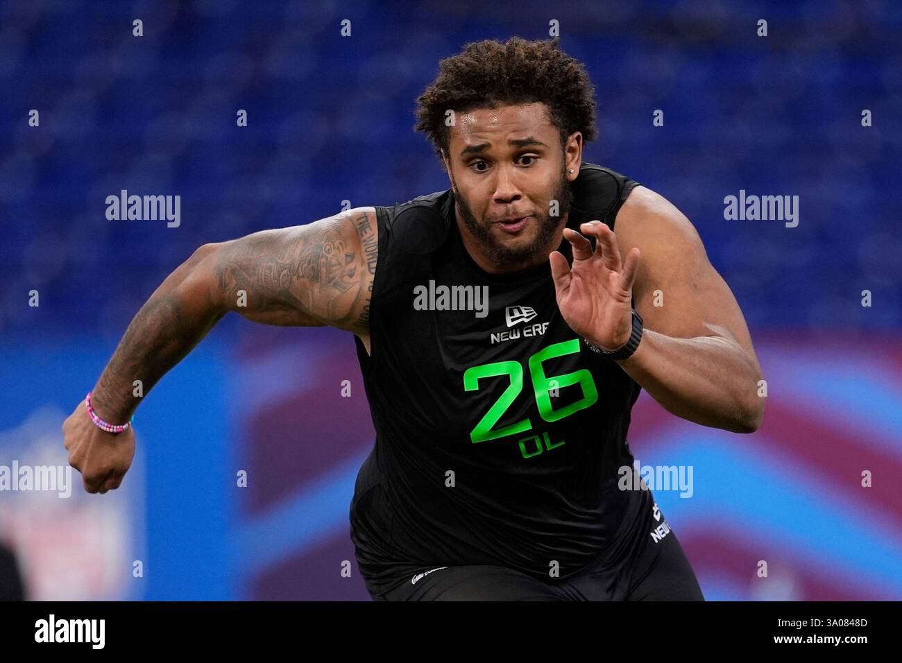 Purdue offensive lineman Marcus Mbow runs a drill at the NFL football ...