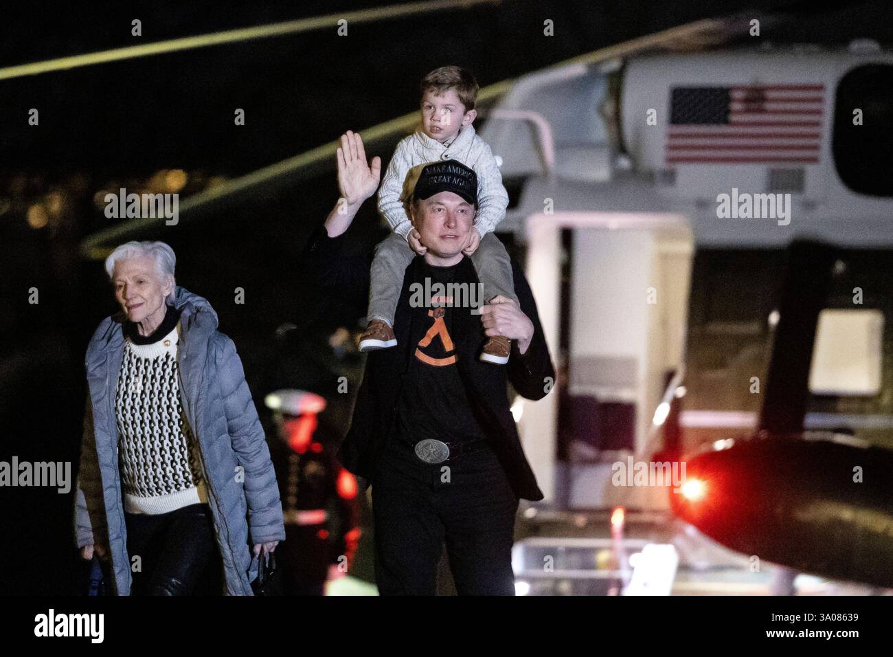 Elon Musk holds his son, X Æ A-12, and walks with his mother, Maye Musk ...