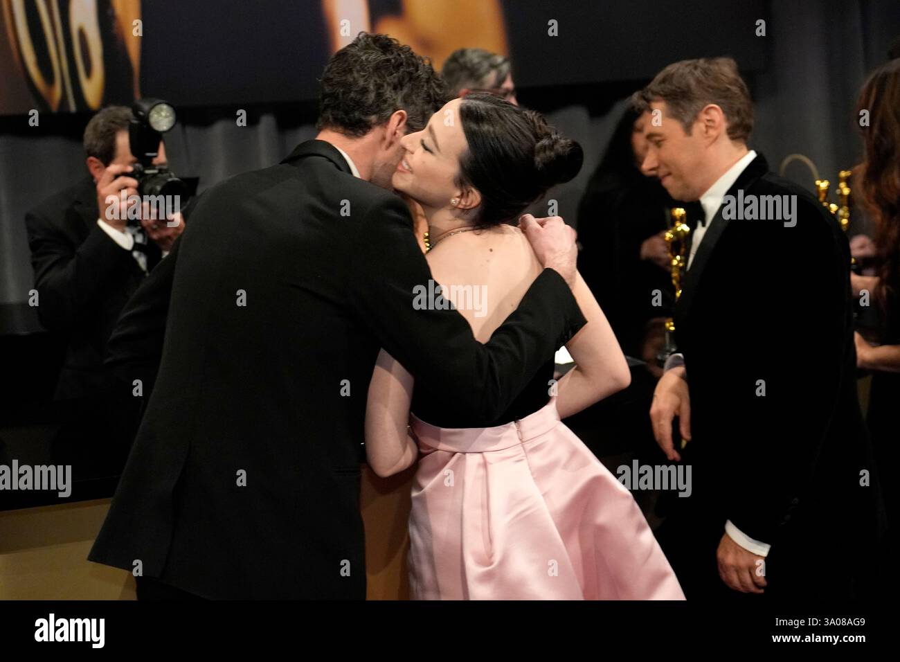 Alex Coco, left, winner of the award for best picture for "Anora," and ...