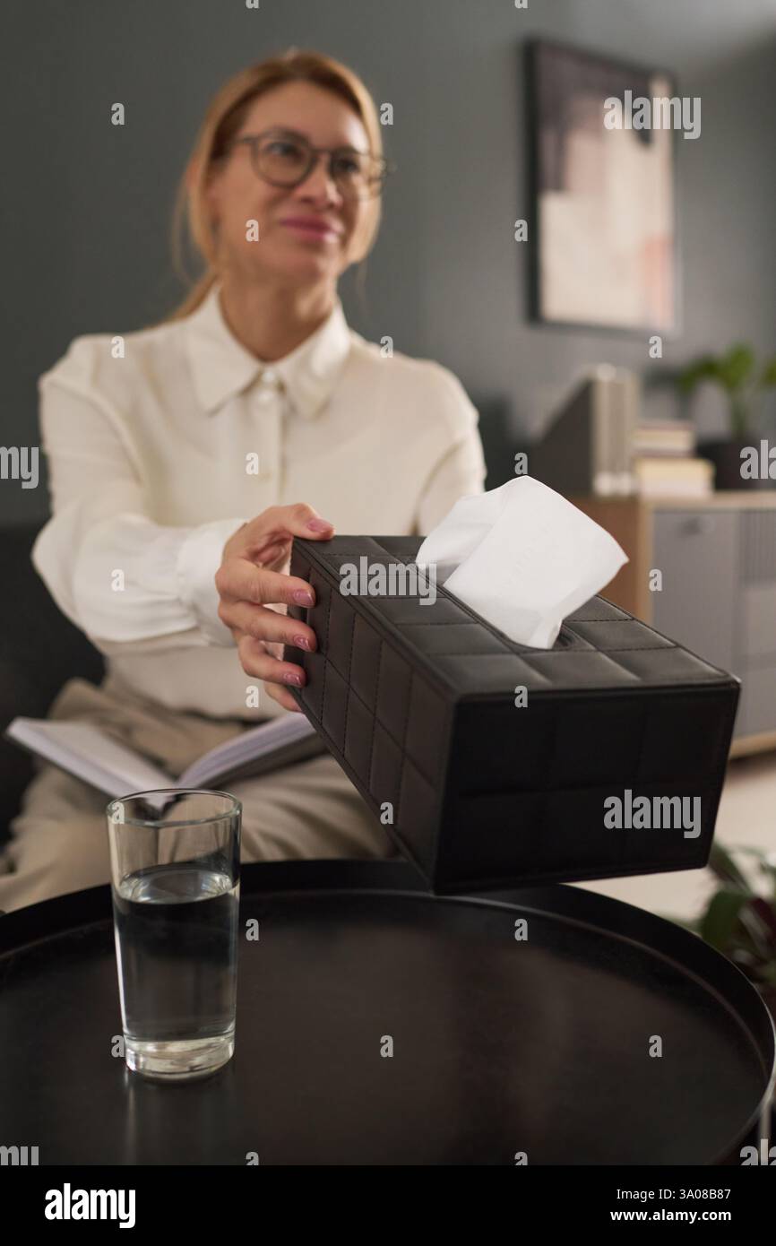 Therapist Handing Box of Tissues to Client Stock Photo - Alamy