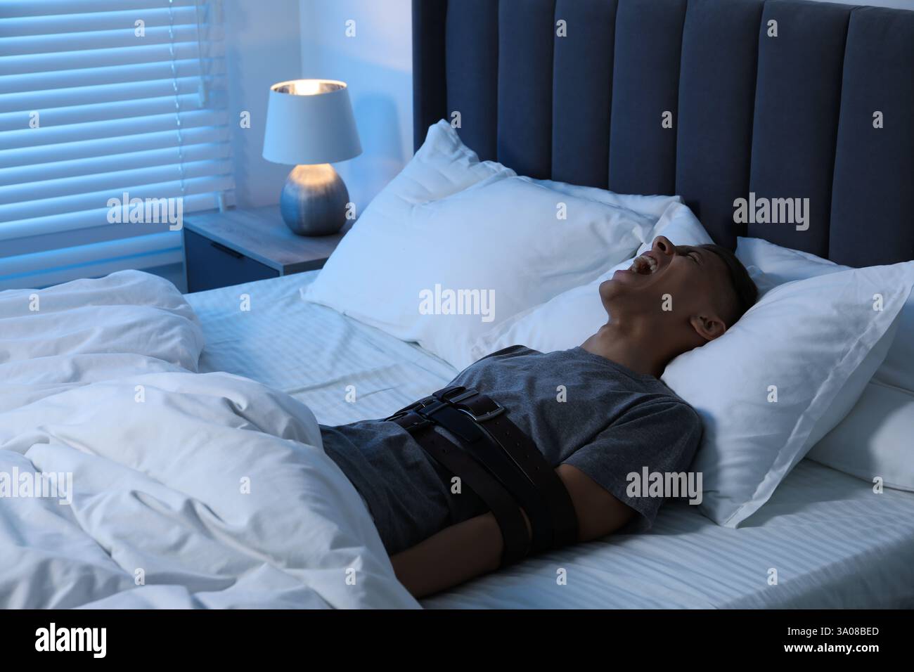 Man in sleepwalking condition screaming in bed Stock Photo - Alamy