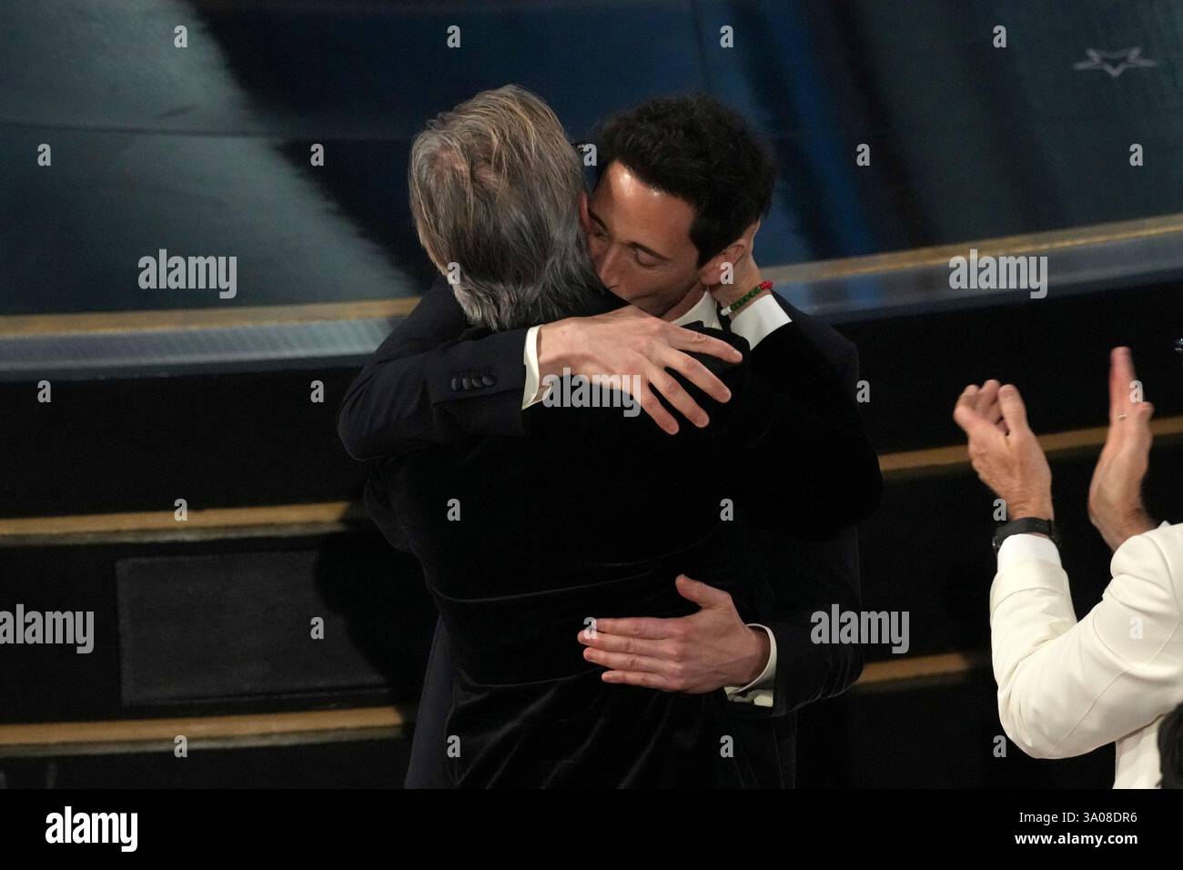 Guy Pearce, left, and Adrien Brody embrace during the Oscars on Sunday ...