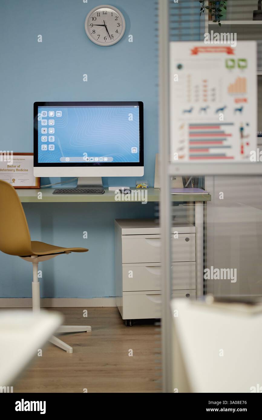 Vertical shot of veterinary doctors office equipped with desktop ...