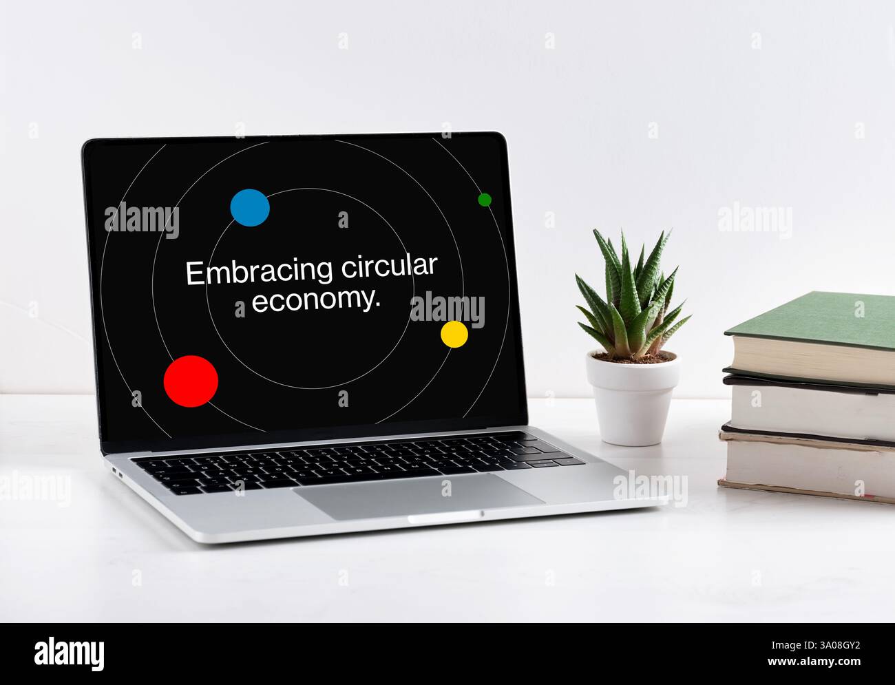 Laptop displaying circular economy concept with orbiting planets ...
