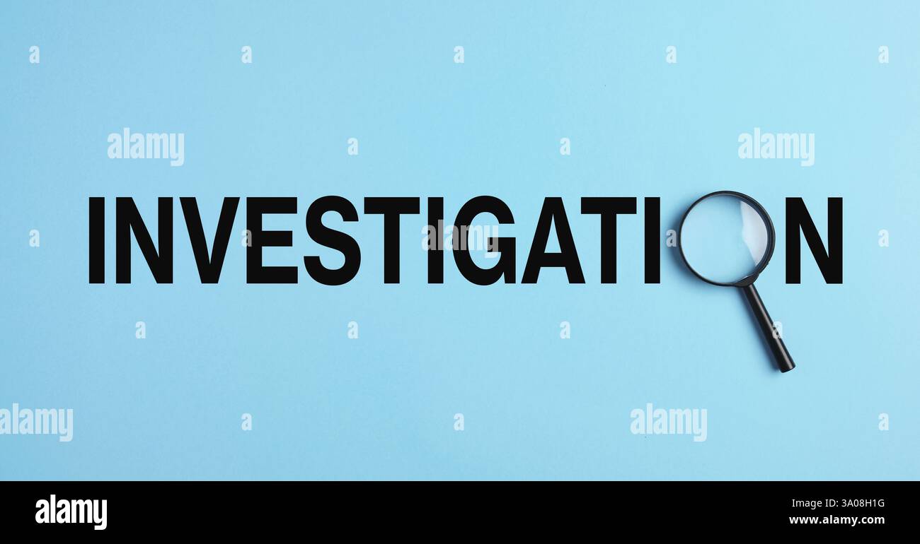 Magnifying glass exploring the word investigation written on a blue ...