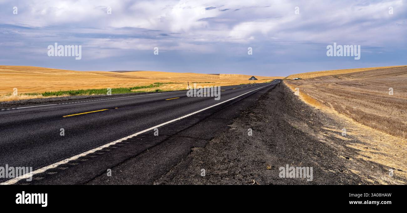 A panorama of a road leading to a distant barn in the Palouse region ...