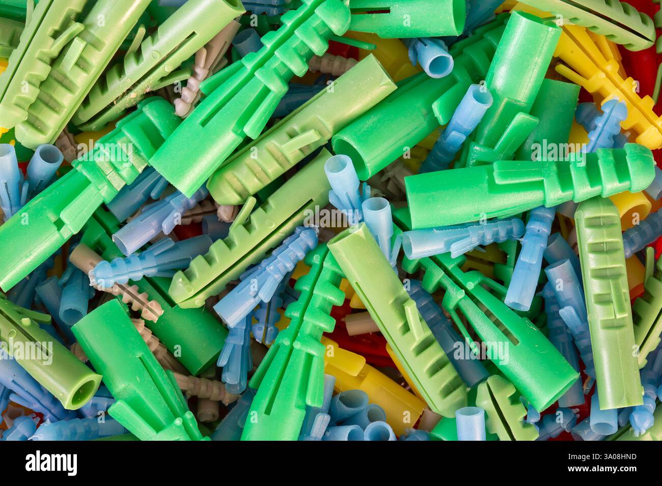 Pile of assorted sizes wall plugs background backdrop. Construction do ...