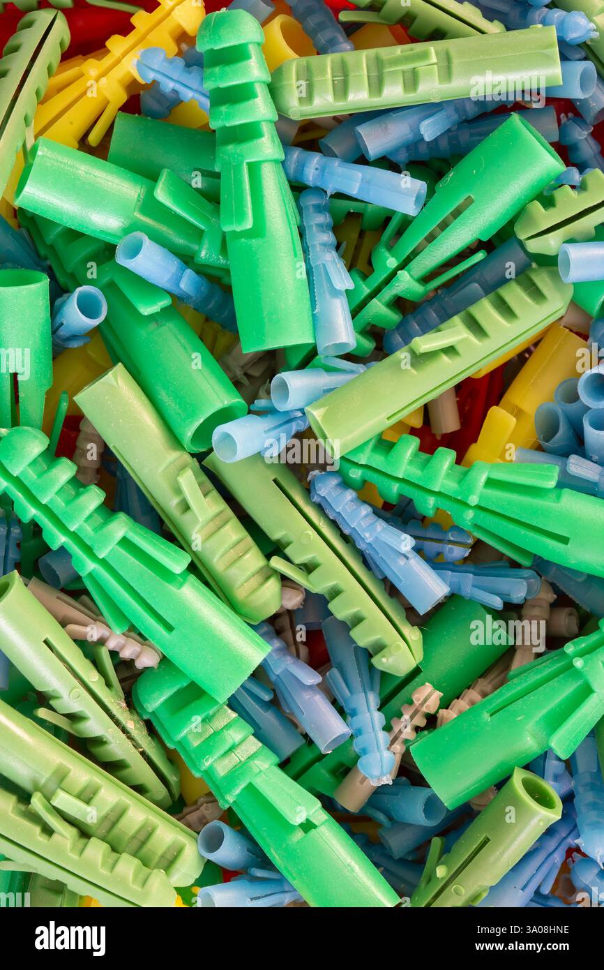 Pile of assorted sizes wall plugs background backdrop. Construction do ...