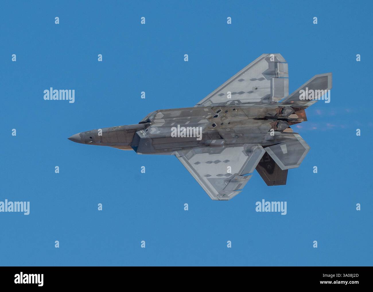 A U.S. Air Force F-22 Raptor aircraft flies over the flightline during ...