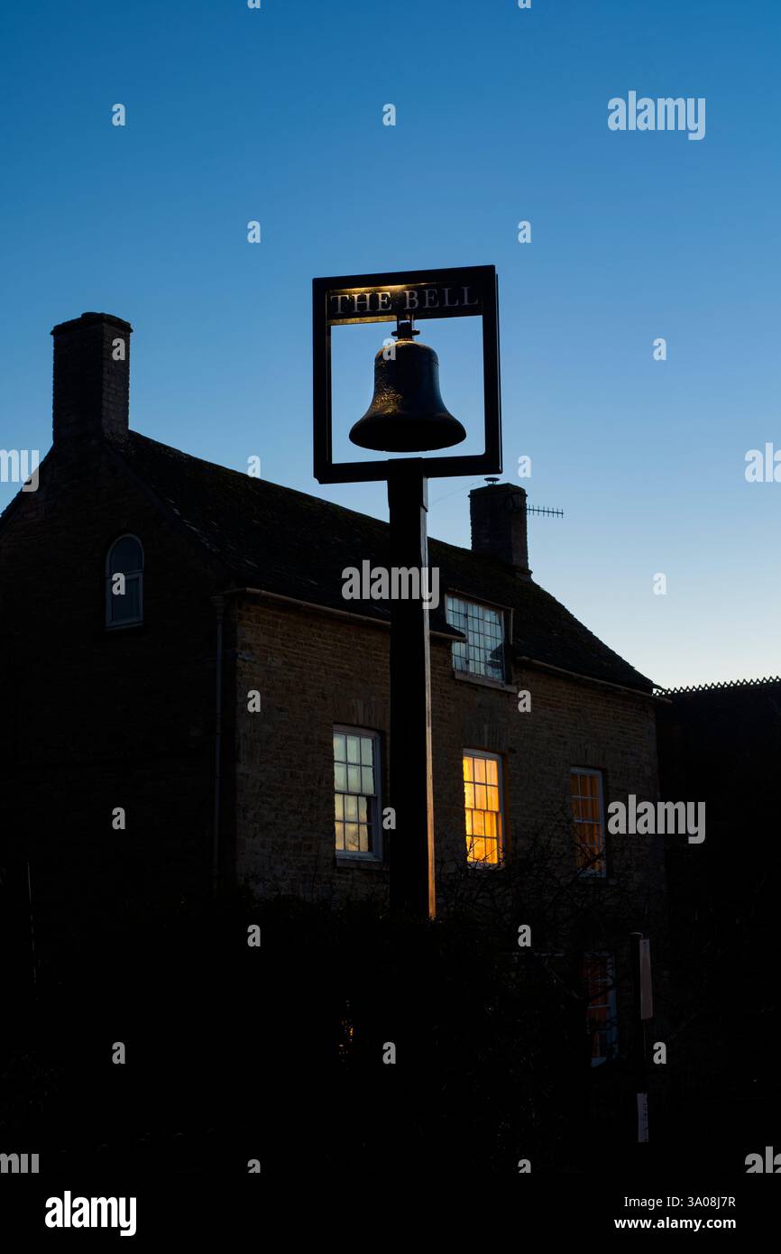 The Bell pub sign at dusk. Charlbury, Oxfordshire, England Stock Photo ...