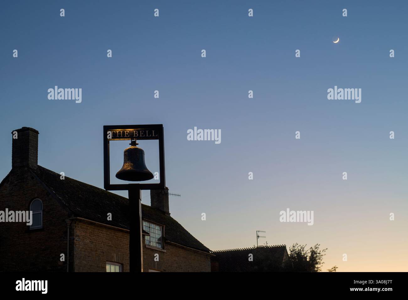 The Bell pub sign at dusk. Charlbury, Oxfordshire, England Stock Photo ...