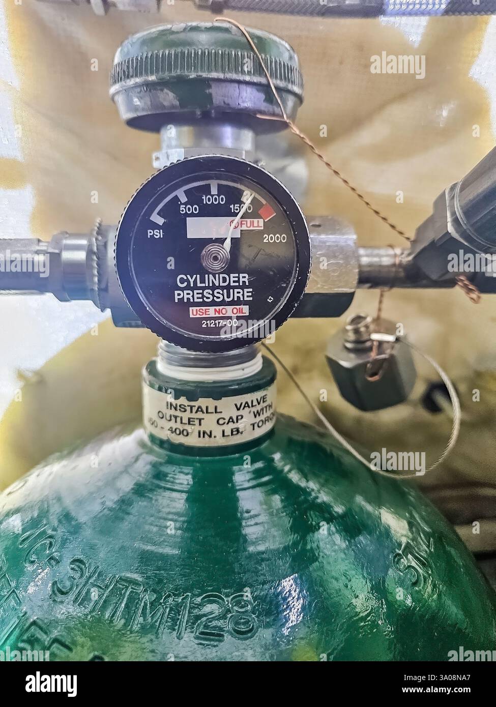 Close-up of a high-pressure gas cylinder with a regulator and gauge ...