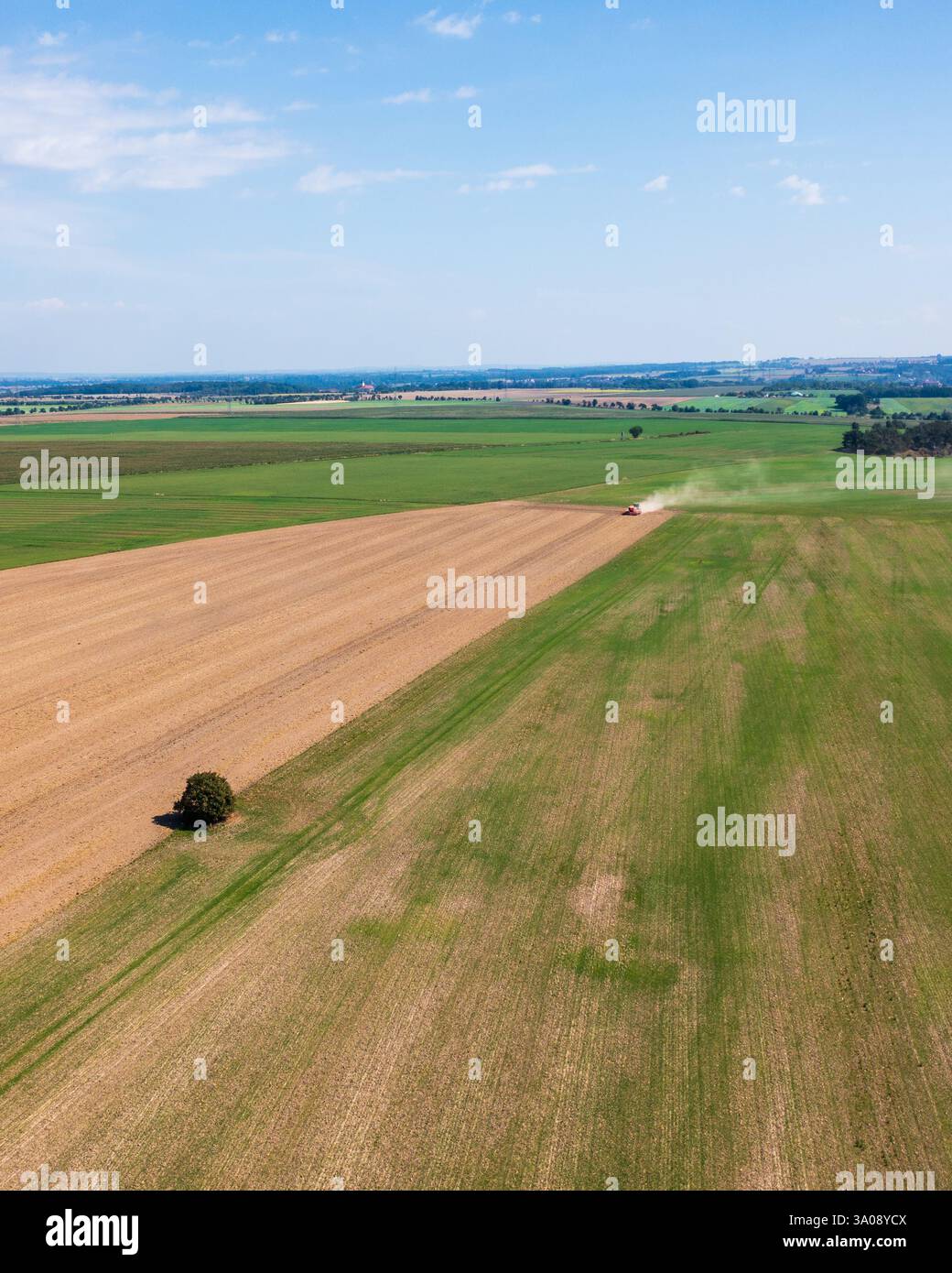 Aerial view an agricultural field, tractor tilling land. Smooth lines ...