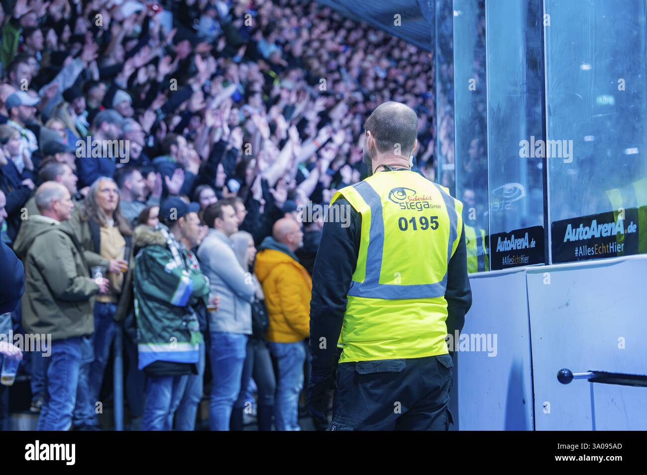 Security guards monitor the cheering crowd at a sporting event ...