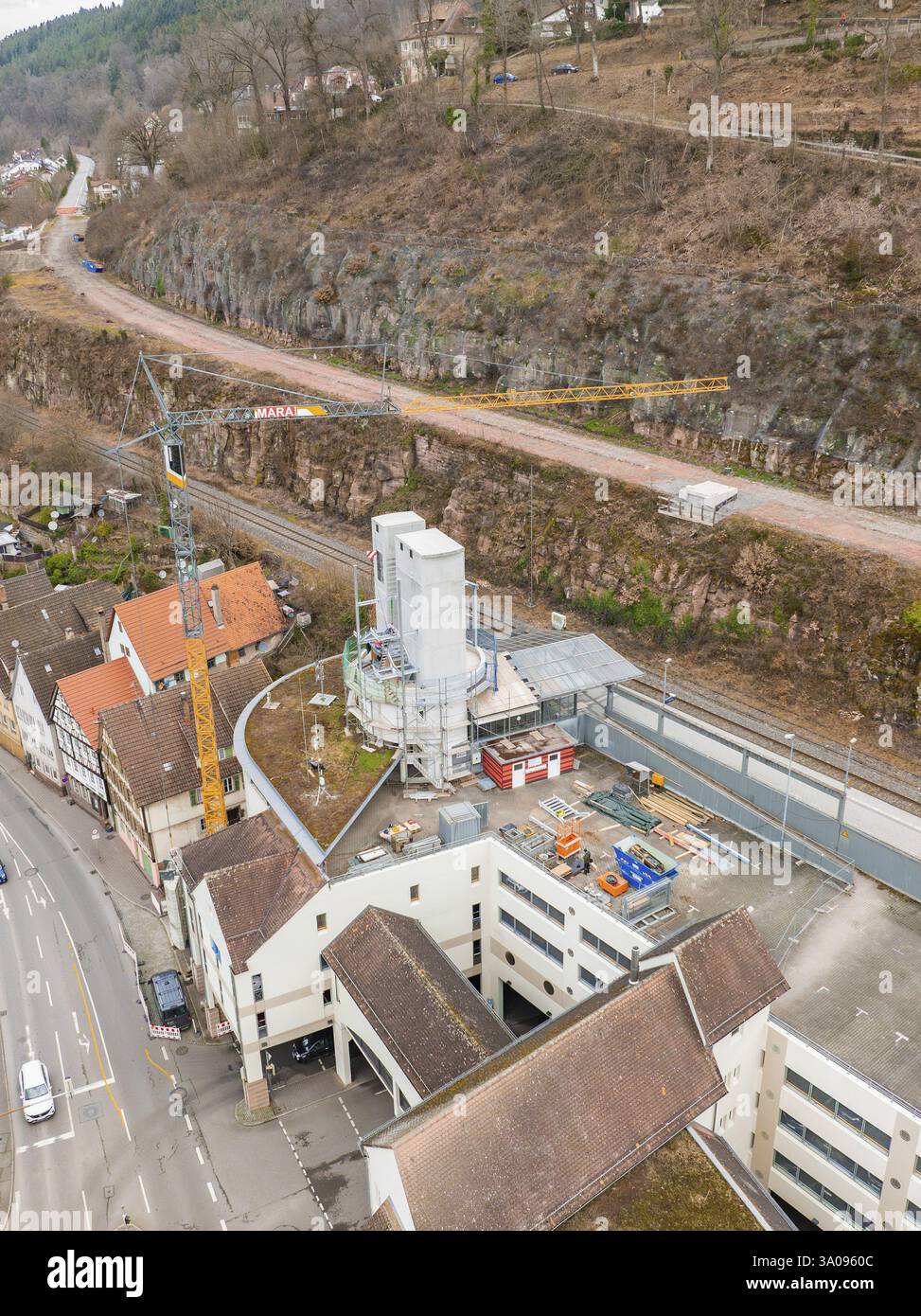 Aerial view of a town with construction site and crane next to a main ...