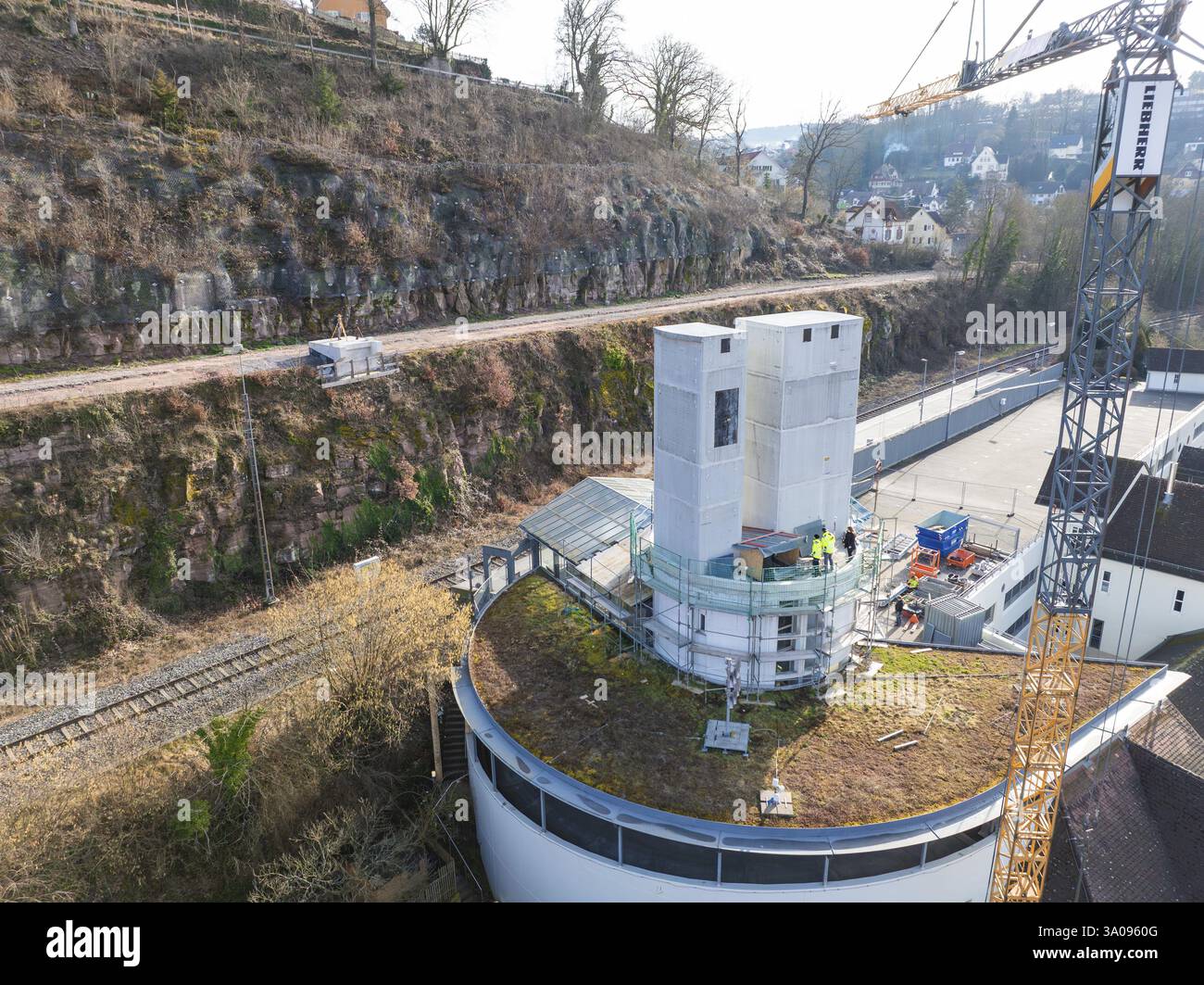 Construction site in a hilly urban landscape with two concrete towers ...