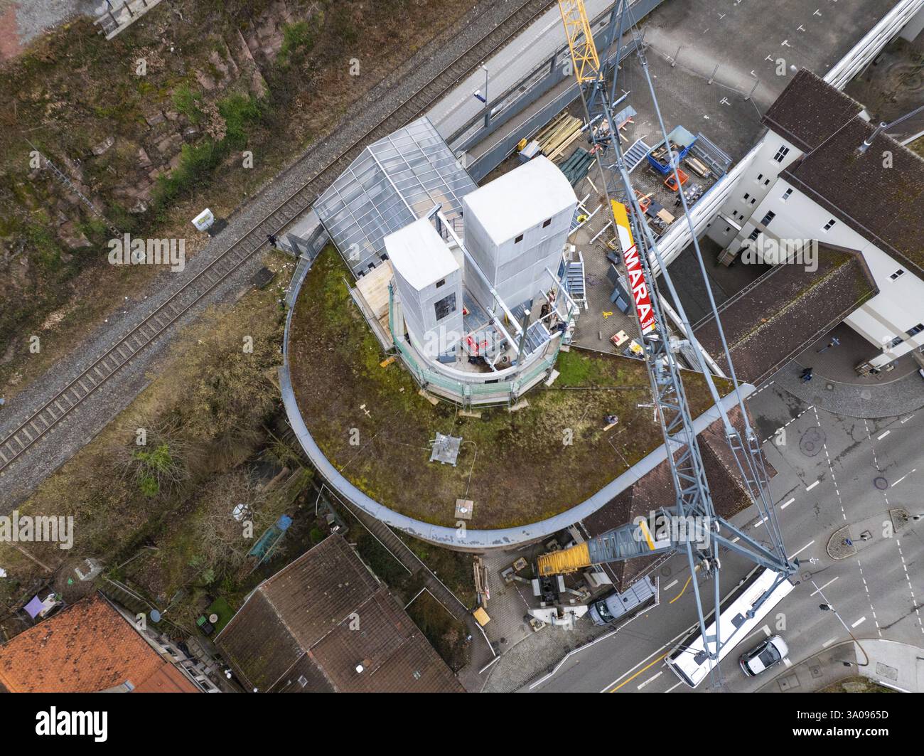 Aerial view of a construction site with crane near railway tracks and ...