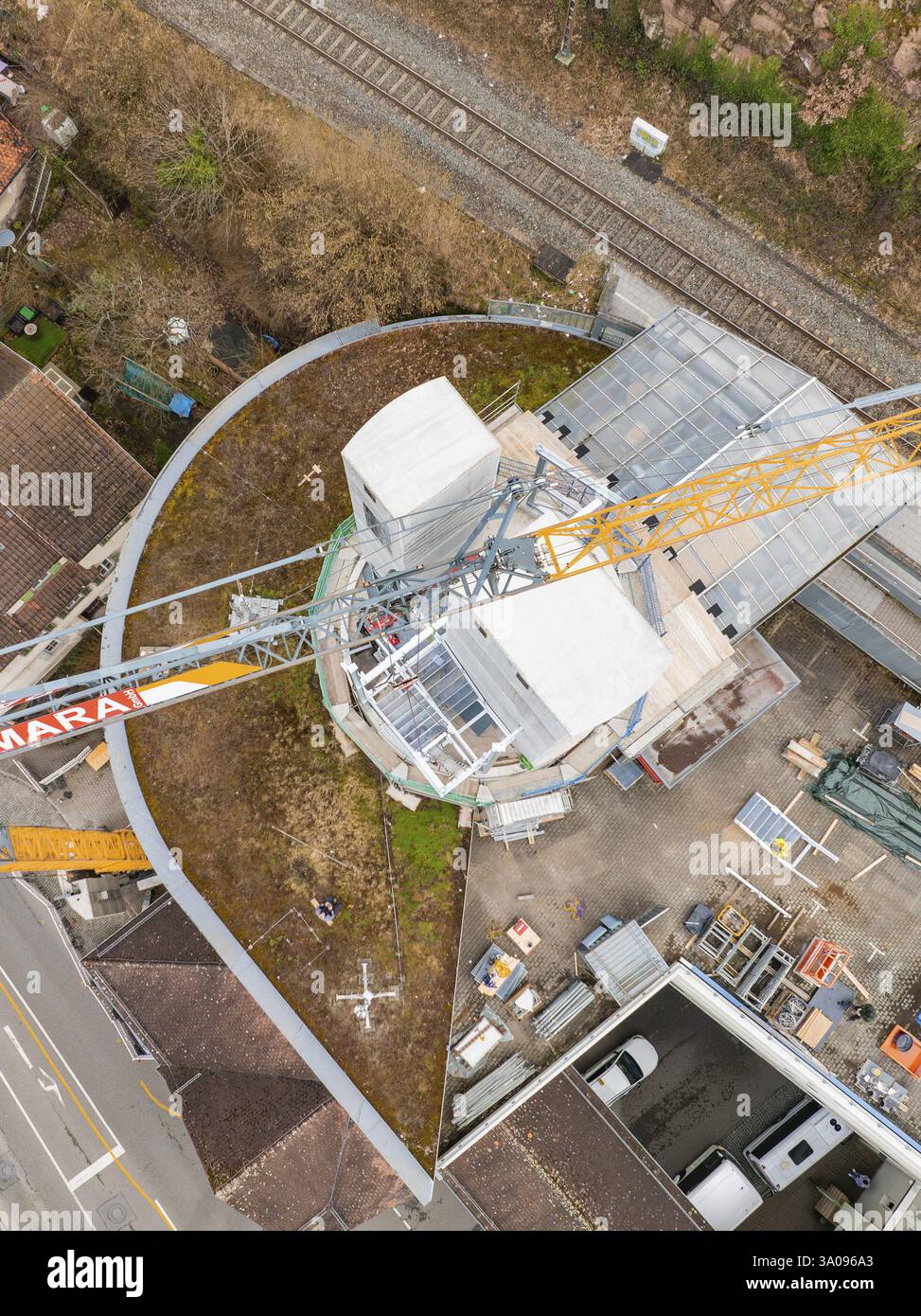 Aerial view of a construction site with a crane next to the railway ...