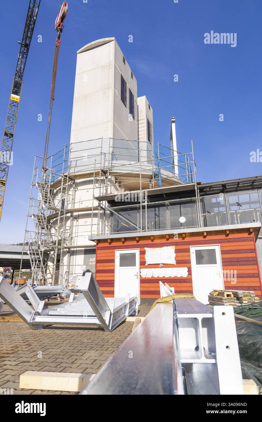 Modern building with scaffolding and crane under a clear sky on a ...