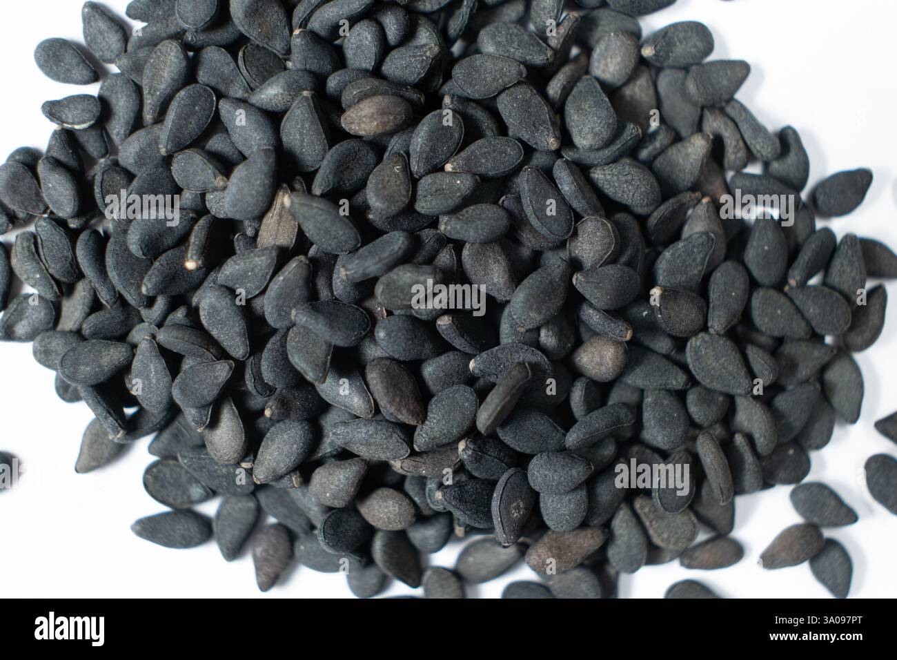 Black sesame seeds scattered on a white background macro top view Stock ...