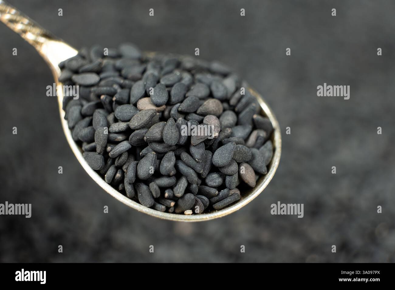 Natural black sesame grains in a spoon macro close-up Stock Photo - Alamy