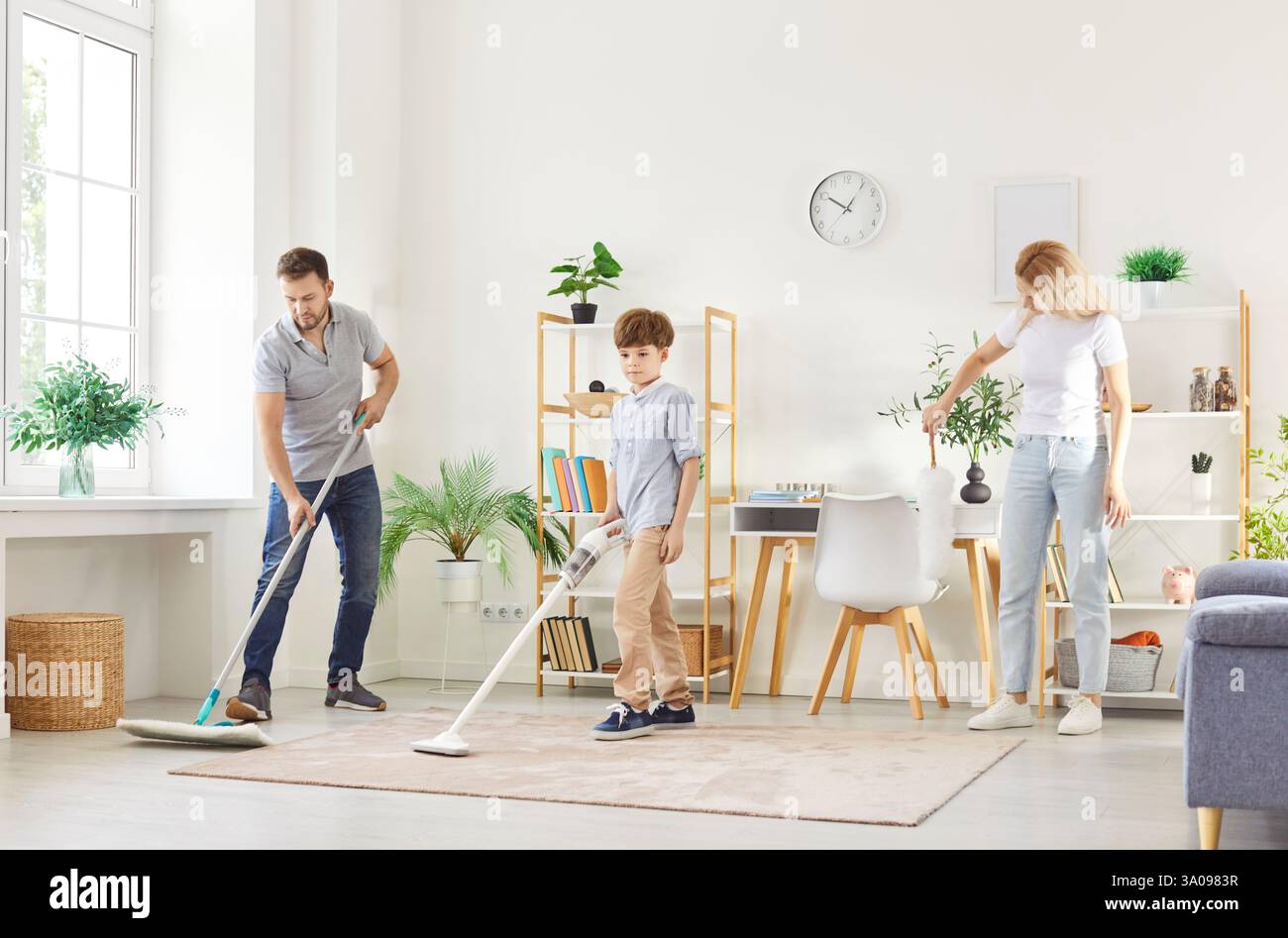 United family doing housework together, cleaning floor and carpet ...